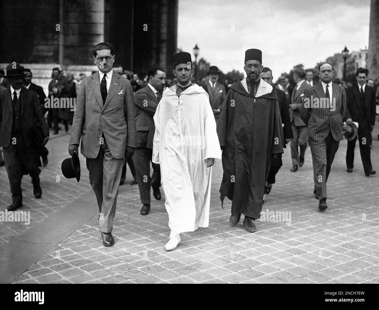 The Sultan of Morocco, Mohammed V wearing white robes, walking with the ...
