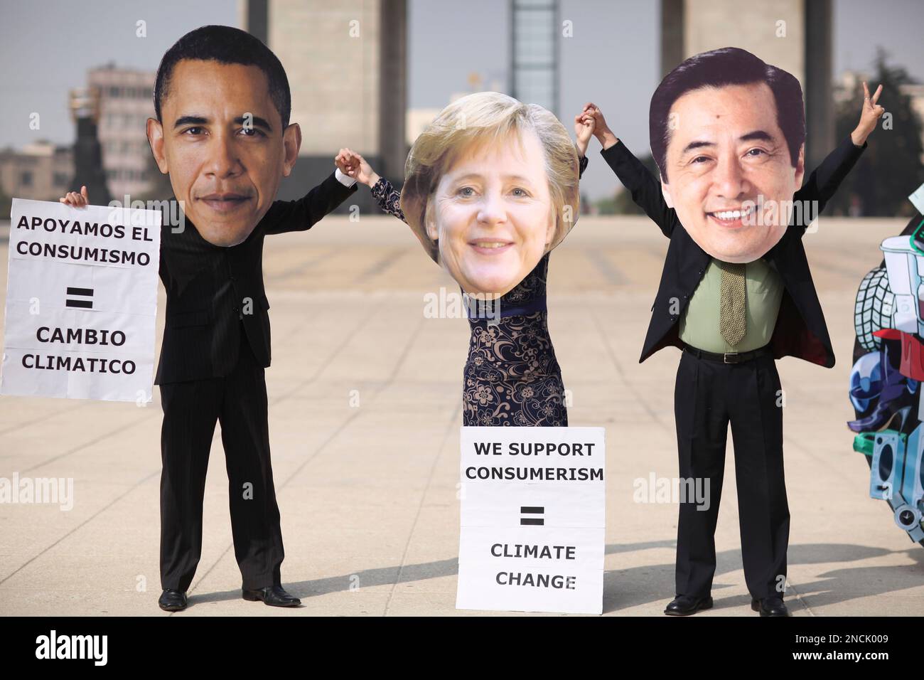 Activists, wearing masks depicting U.S. President Barack Obama, left ...