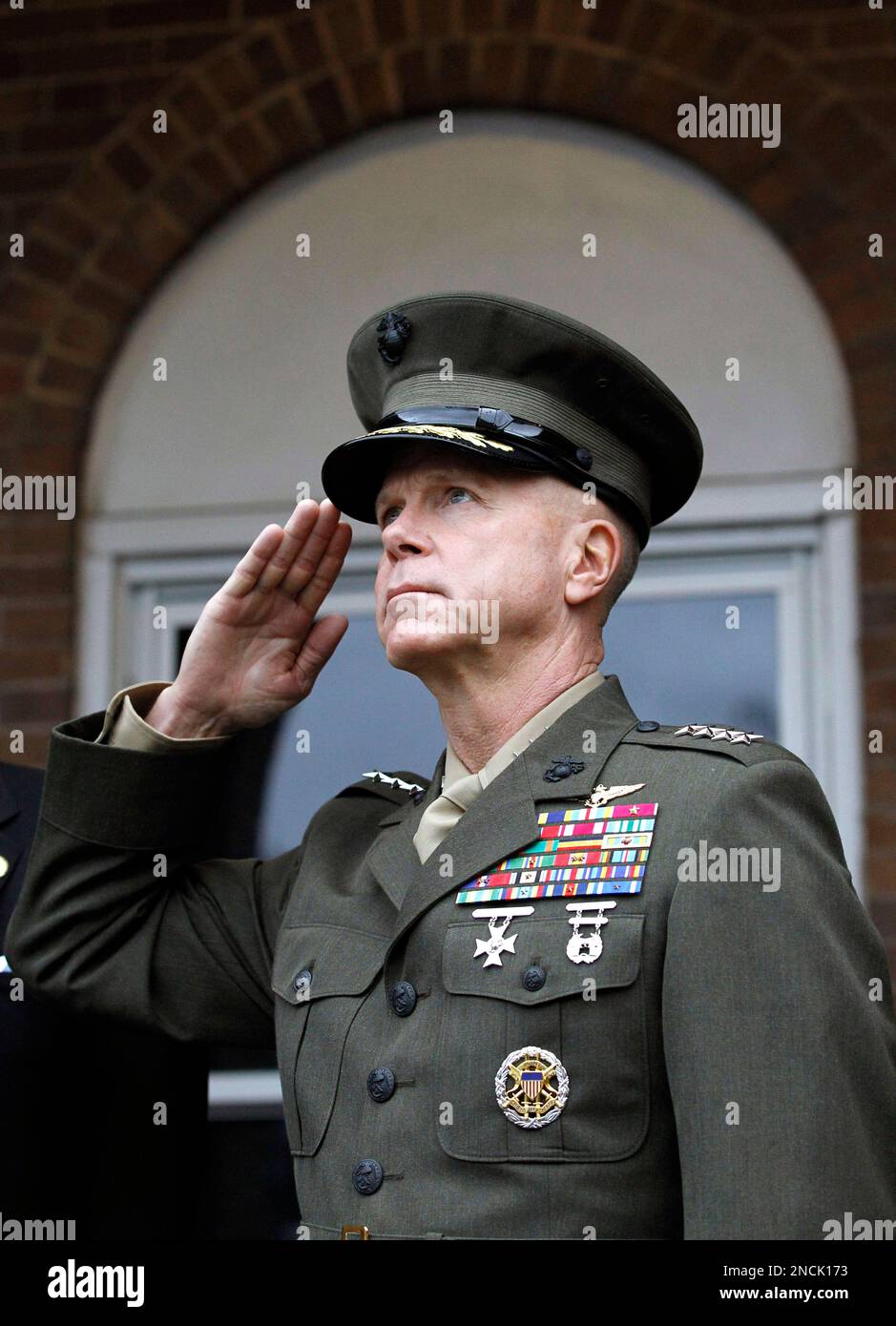 Marine Corps Commandant Gen. James Amos salutes as the colors are ...