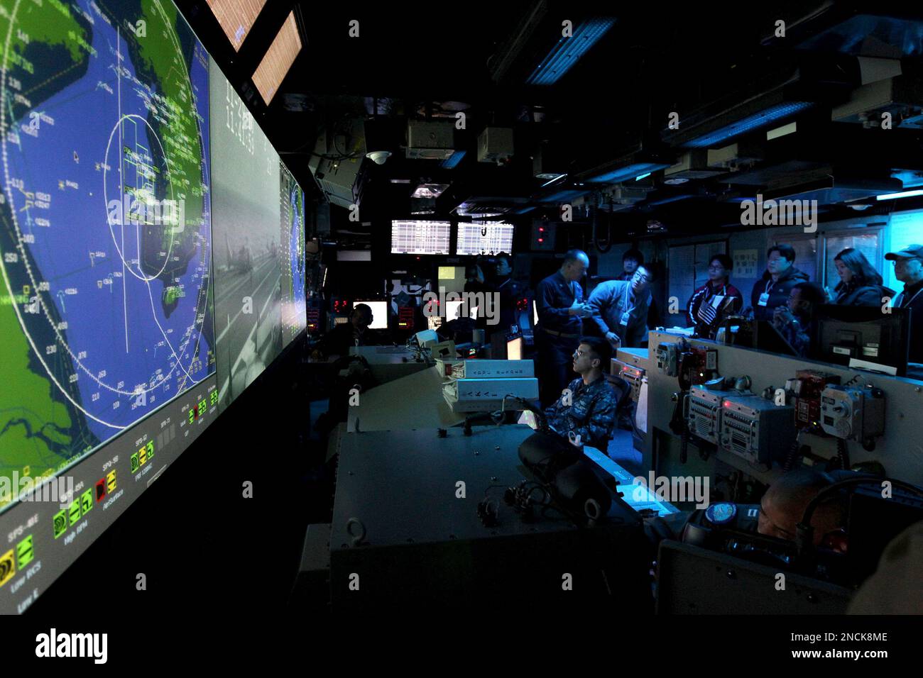 U.S. Navy personnel watch the monitor screens aboard the U.S. Navy's ...