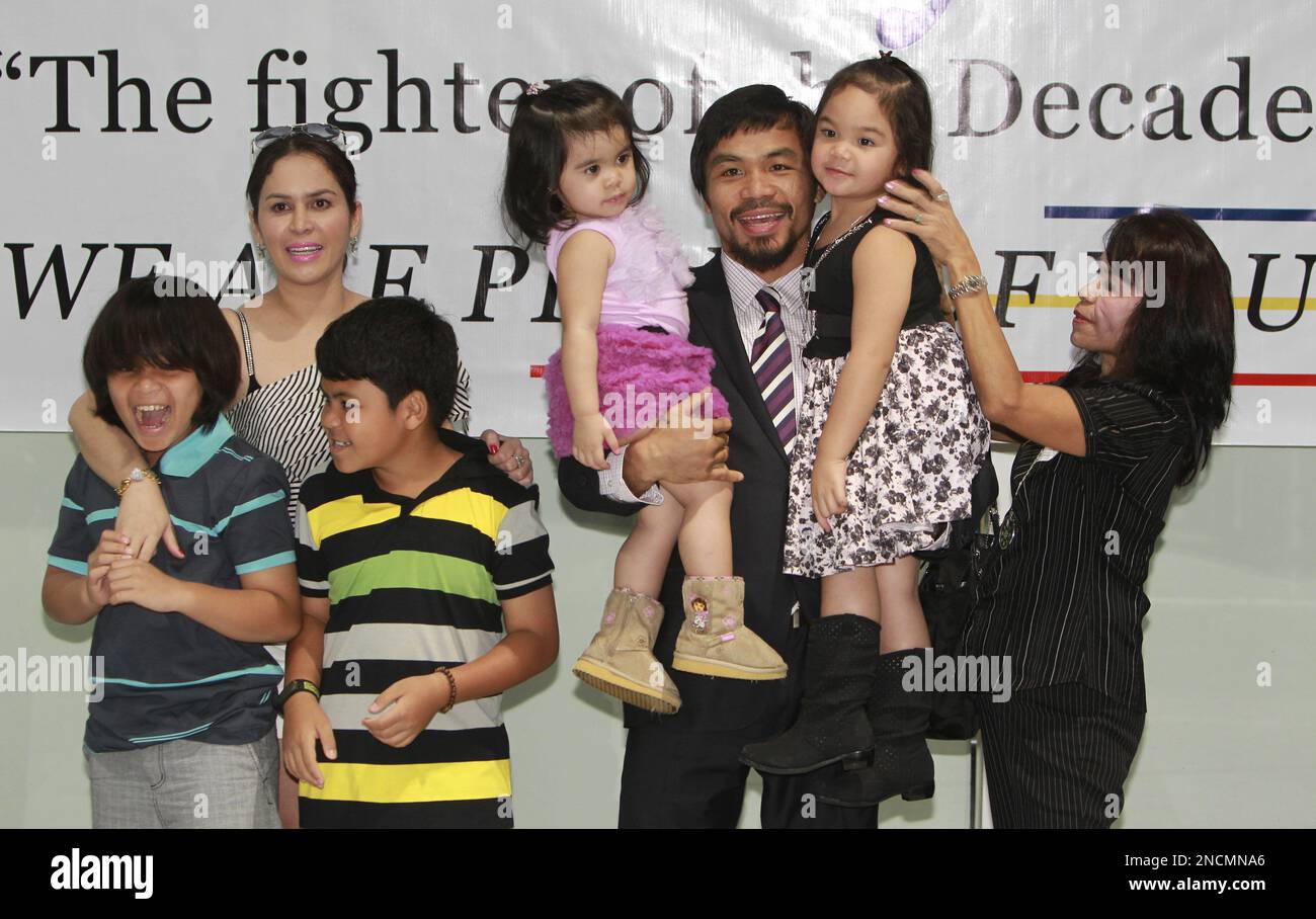 Filipino boxing champion Manny Pacquiao hugs his daughters Princess ...