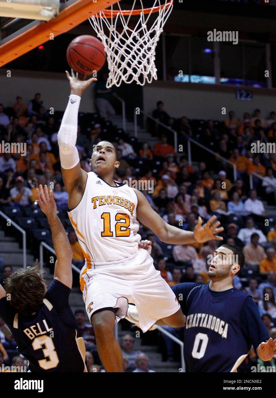 Tennessee's Tobias Harris (12) shoots between Chattanooga's Keegan Bell ...