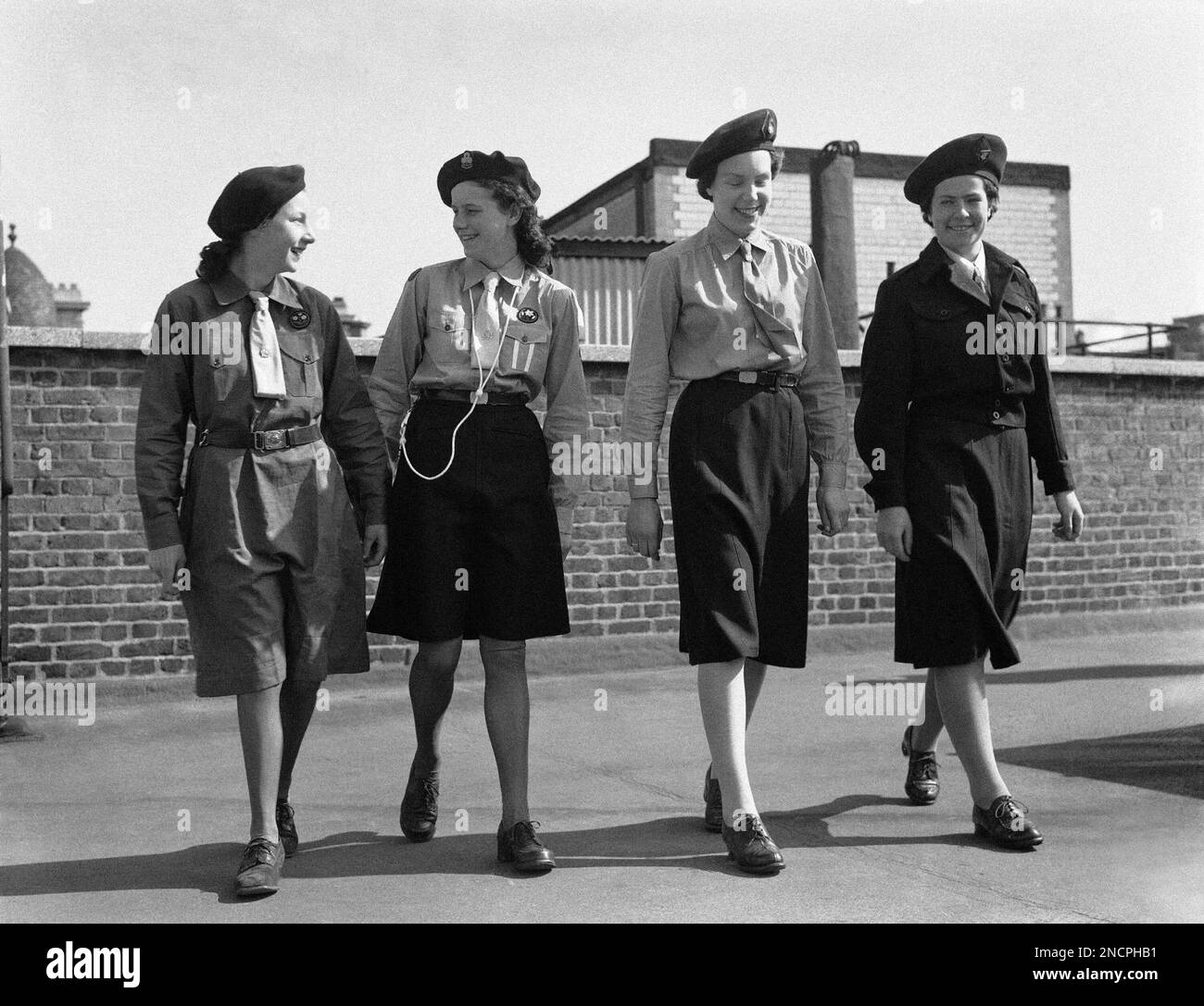 Four Girl Guides display the new Guide uniform at their headquarters in ...