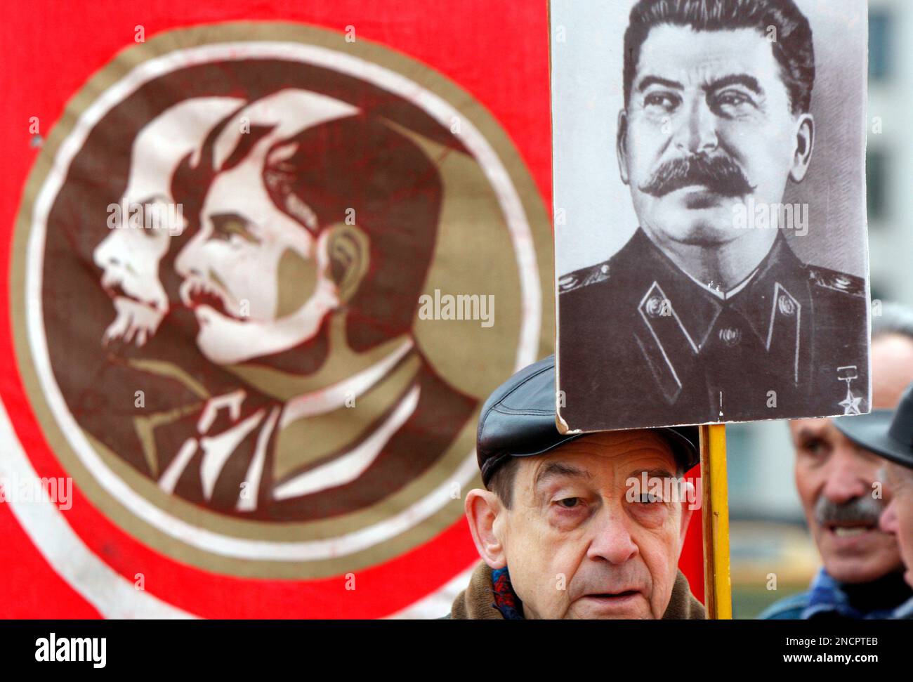 A member of the Belarusian Communist party holding a portraits of Josef ...