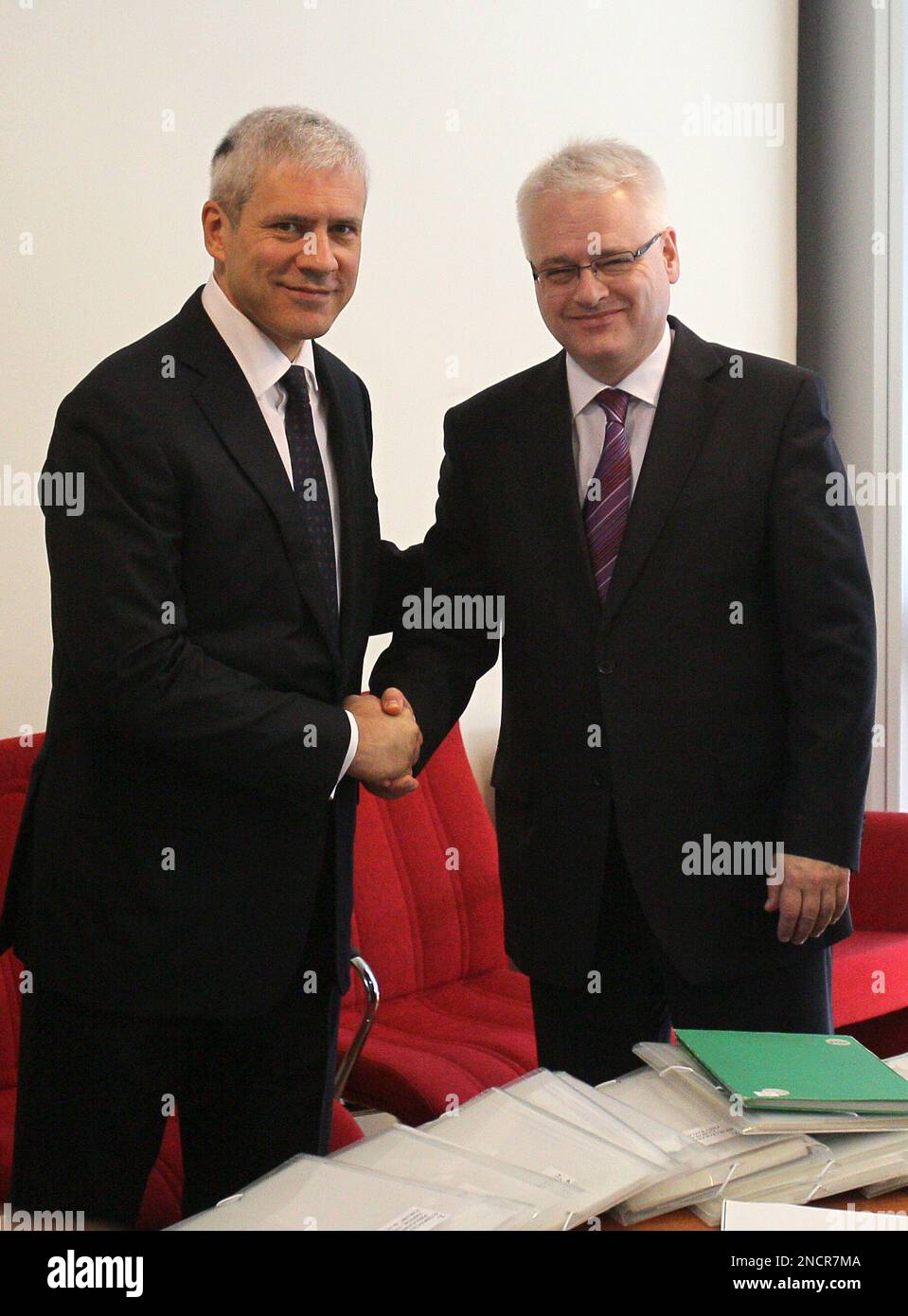 Croatian President Ivo Josipovic, right, shakes hands with his Serbian ...