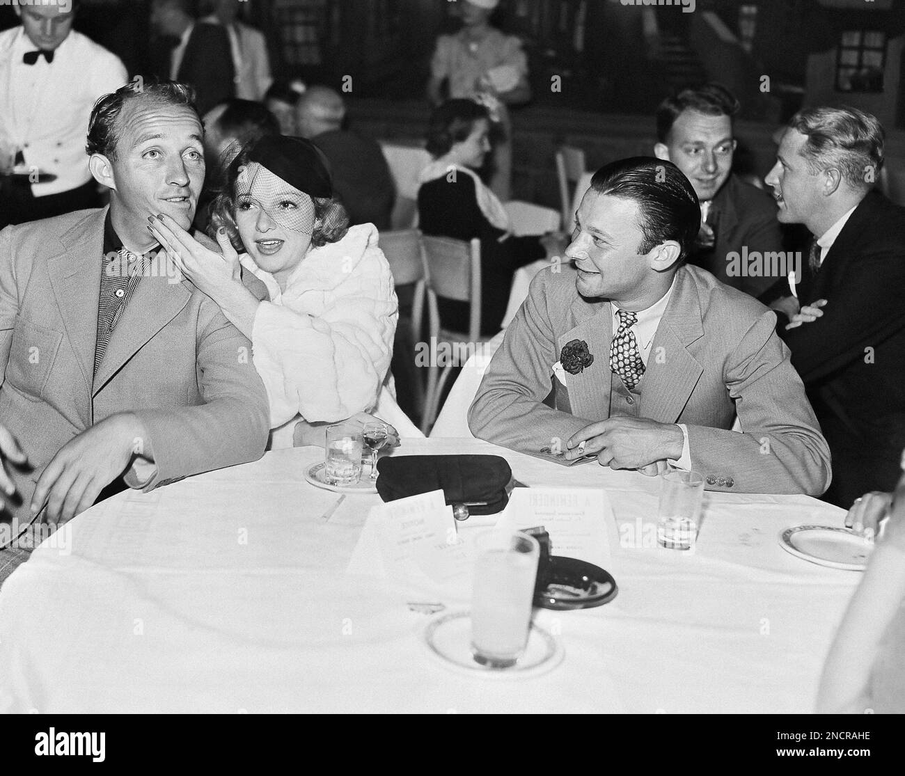 Bing Crosby gets a pat on the cheek from his wife, Dixie Lee, at a Hollywood restaurant in Los ...