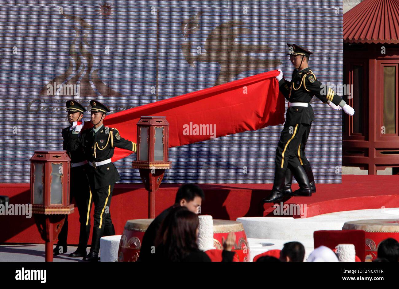 Chinese paramilitary police carry a Chinese national flag past the ...