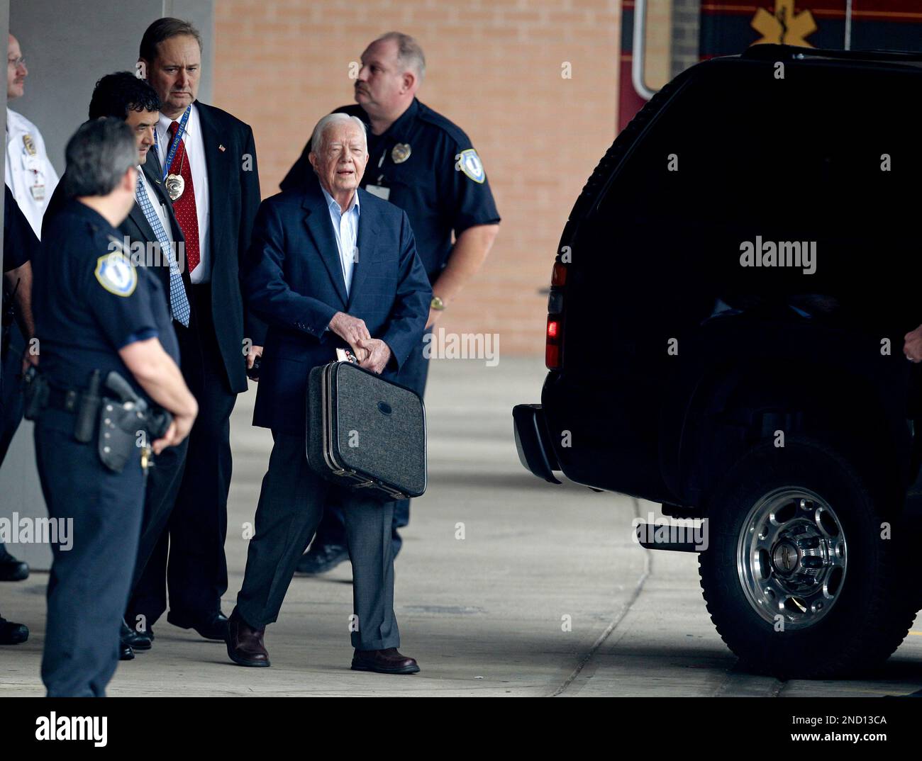 Former President Jimmy Carter walks to a waiting vehicle as he leaves ...