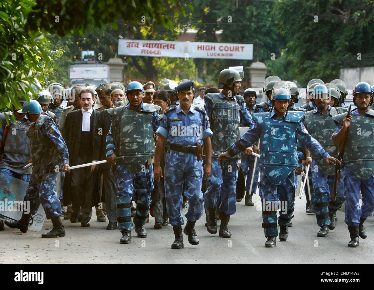 Lawyers for the Muslim community are escorted by paramilitary soldiers ...