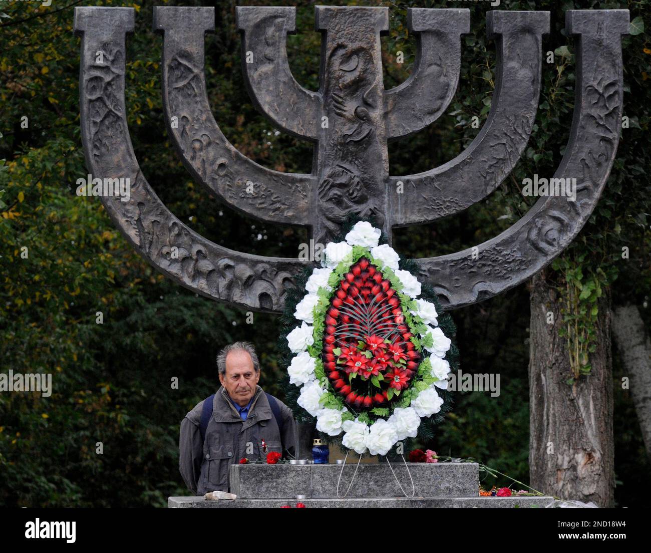 A man mourns at the menorah monument close to a Babi Yar ravine where ...