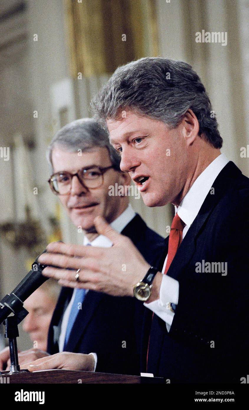 President Bill Clinton gestures as British Prime Minister John Major ...
