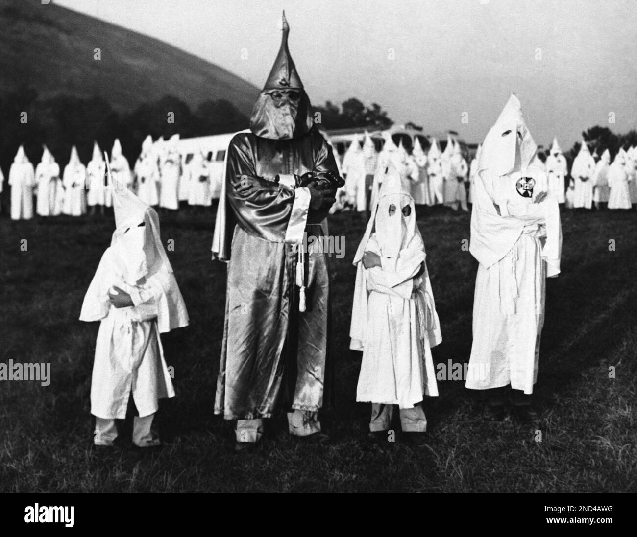 Two little mascots, equipped with their own robes and hoods, flank Dr. Samuel Green, Ku Klux ...