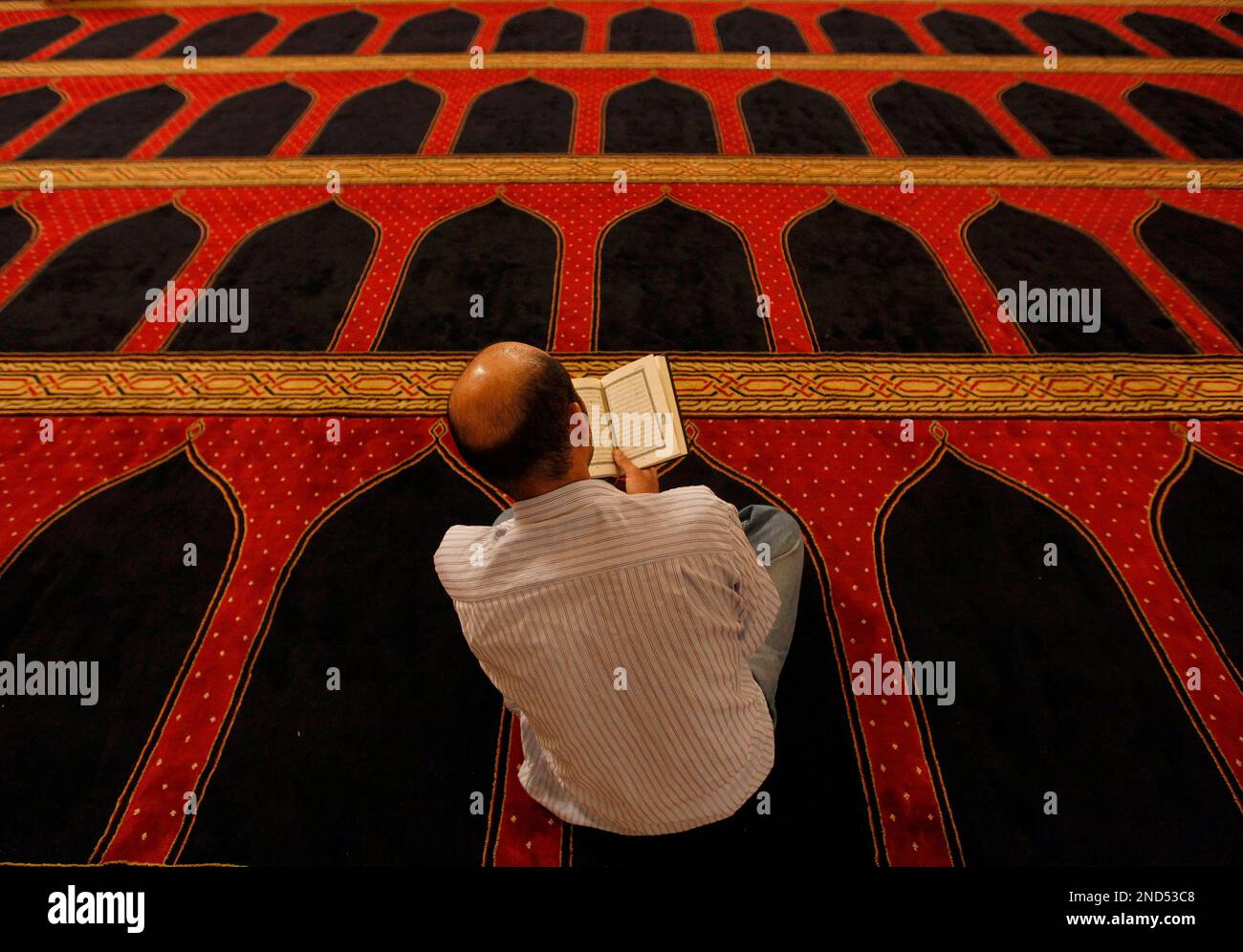 A Lebanese Muslim man reads verses of the Quran, the Muslims holy book ...