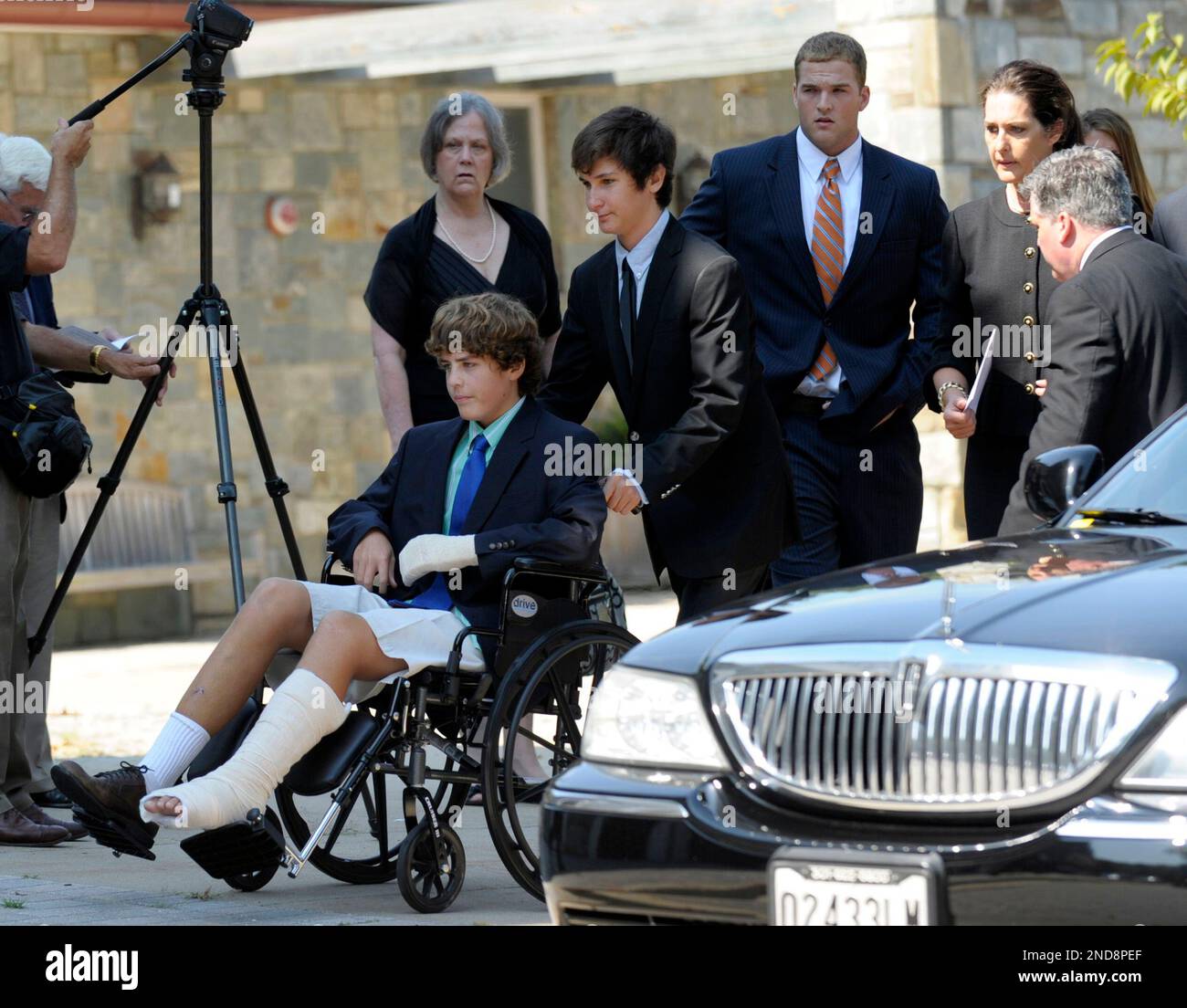 William "Willy" Phillips Jr. is pushed in a wheelchair by his friend ...