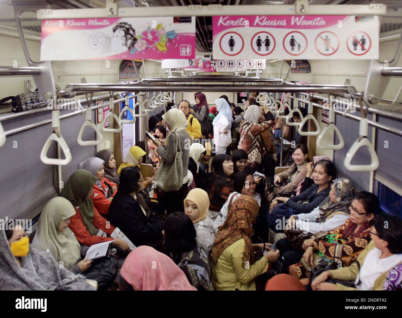 Indonesian women board a women-only carriage of a commuter train on the ...