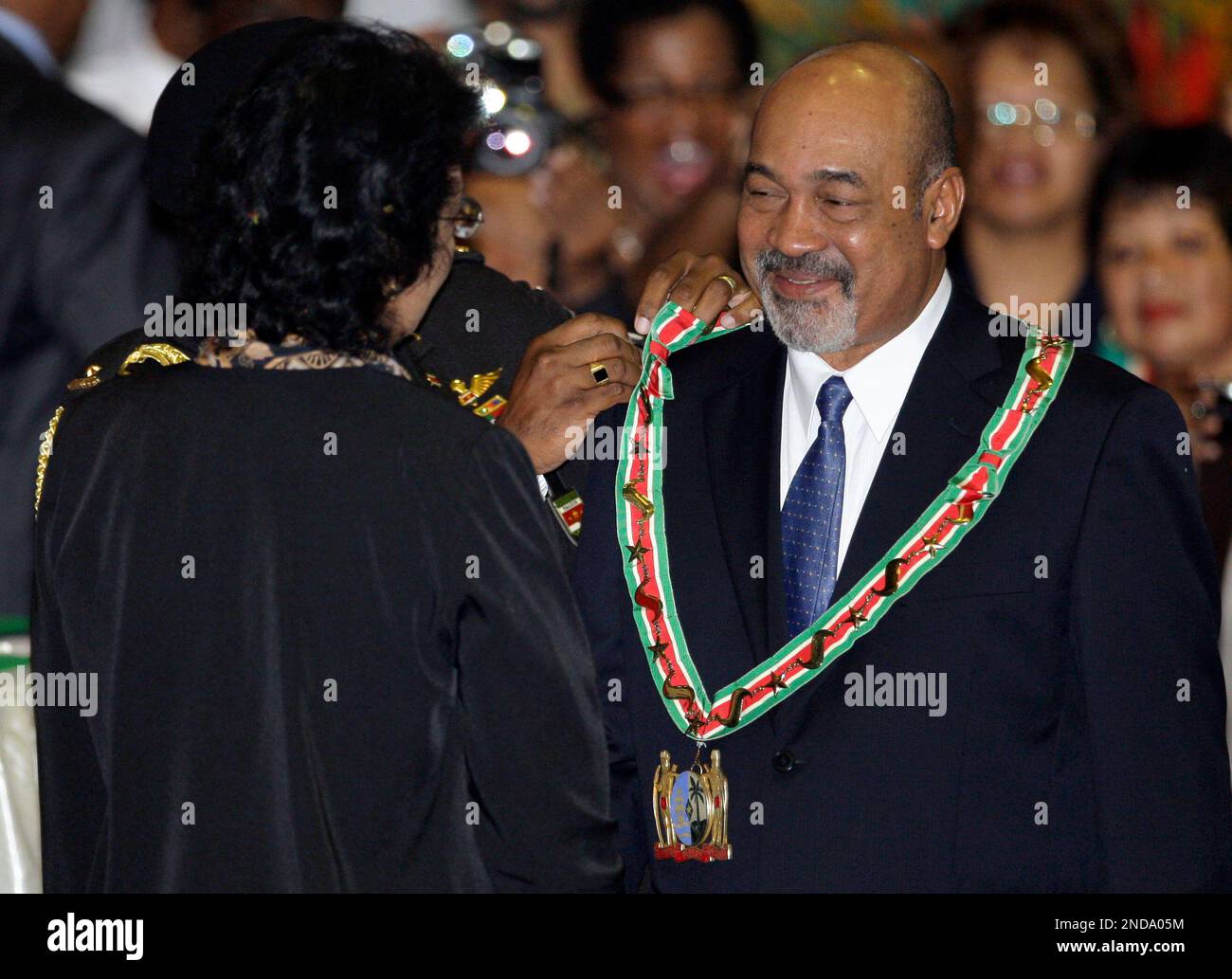 Suriname's President Desi Bouterse, right, smiles after the Parliament ...