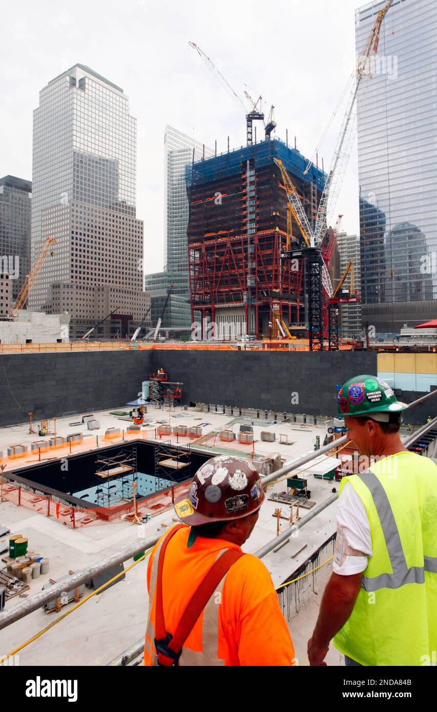 Construction workers overlook the National September 11 Memorial and ...