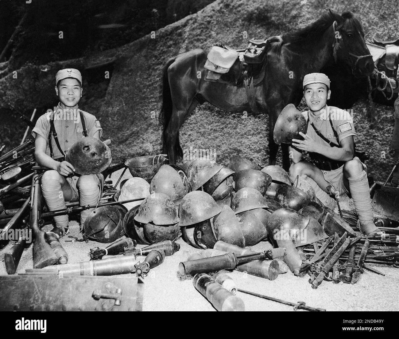 These Chinese soldiers smile happily amid a collection of arms and ...