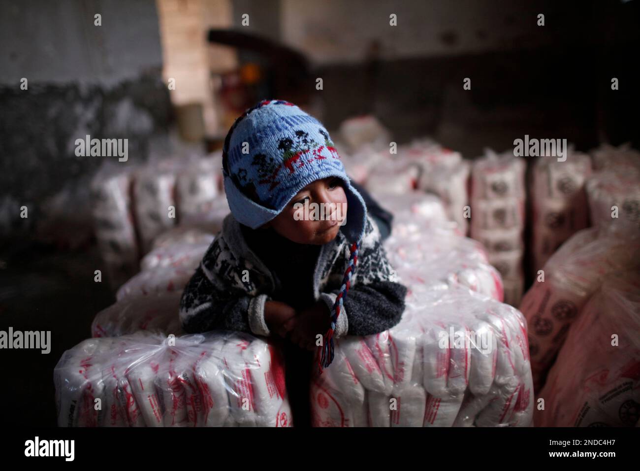 In this photo taken Monday July, 26, 2010, the child of a salt miner ...