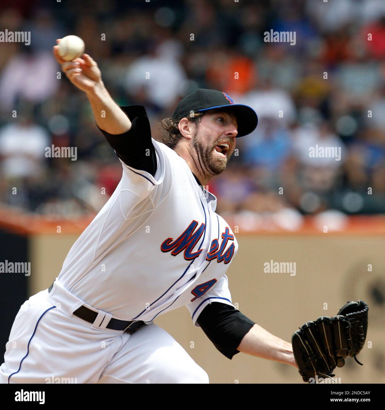 New York Mets starting pitcher R.A. Dickey delivers in the second ...