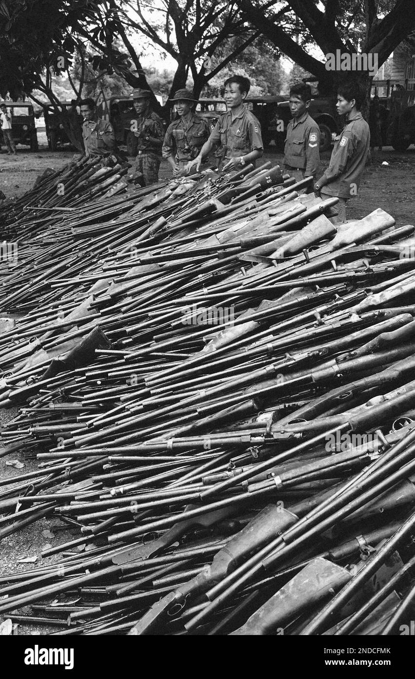 South Vietnamese troops look over a large stack of rifles captured from ...