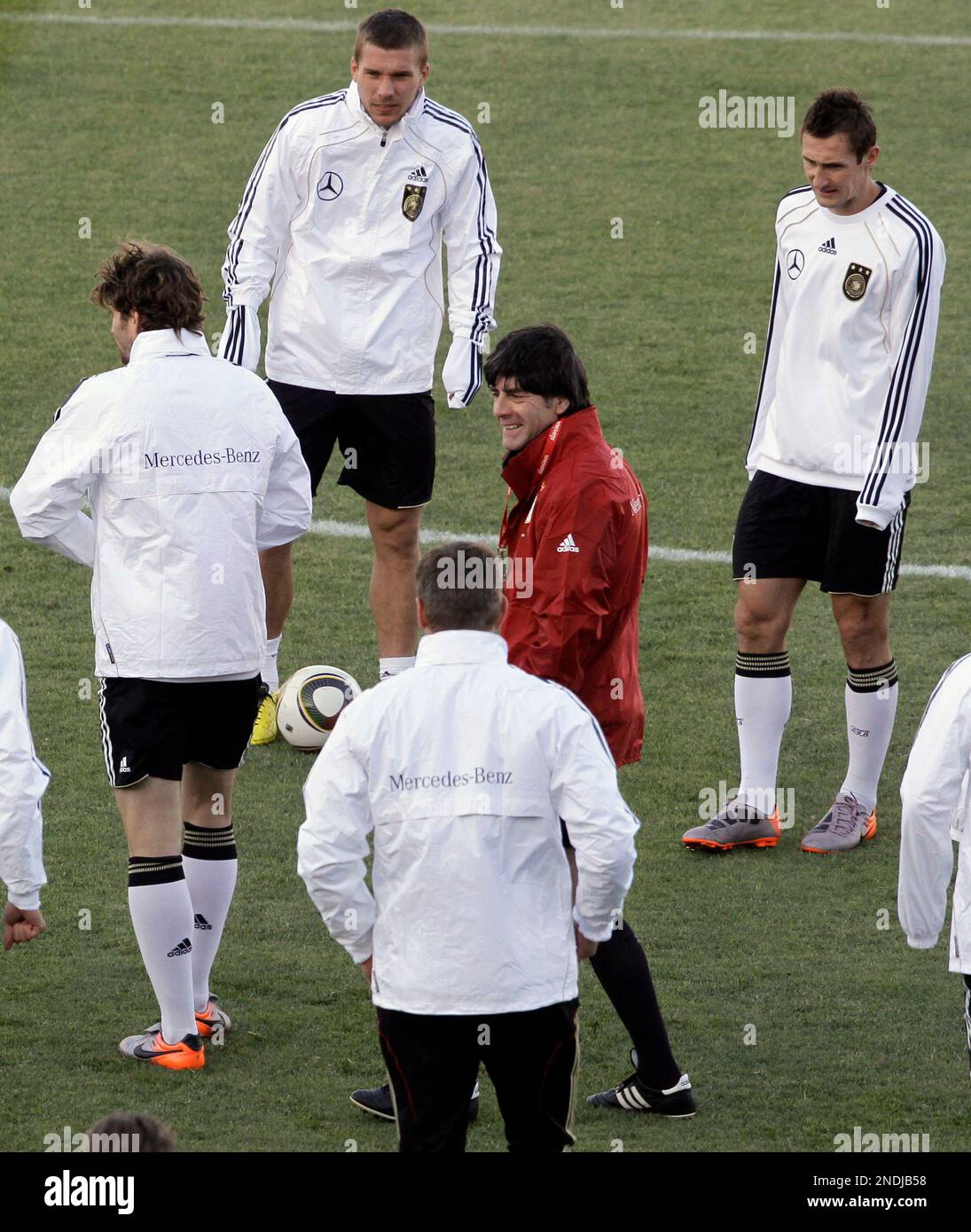 Germany's Arne Friedrich, Lukas Podolski, head coach Joachim Loew and ...