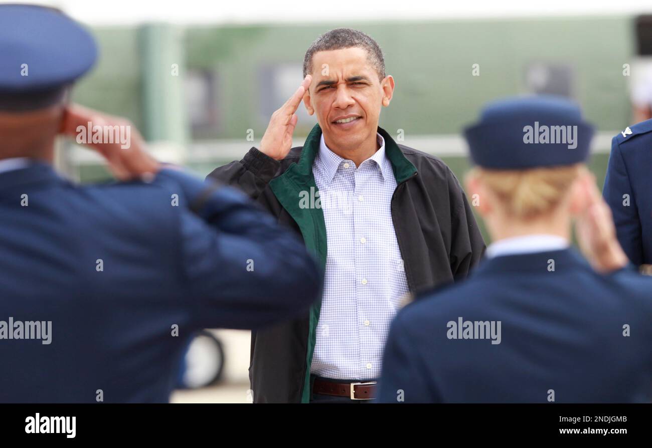 President Barack Obama returns a salute prior to boarding Air Force One ...