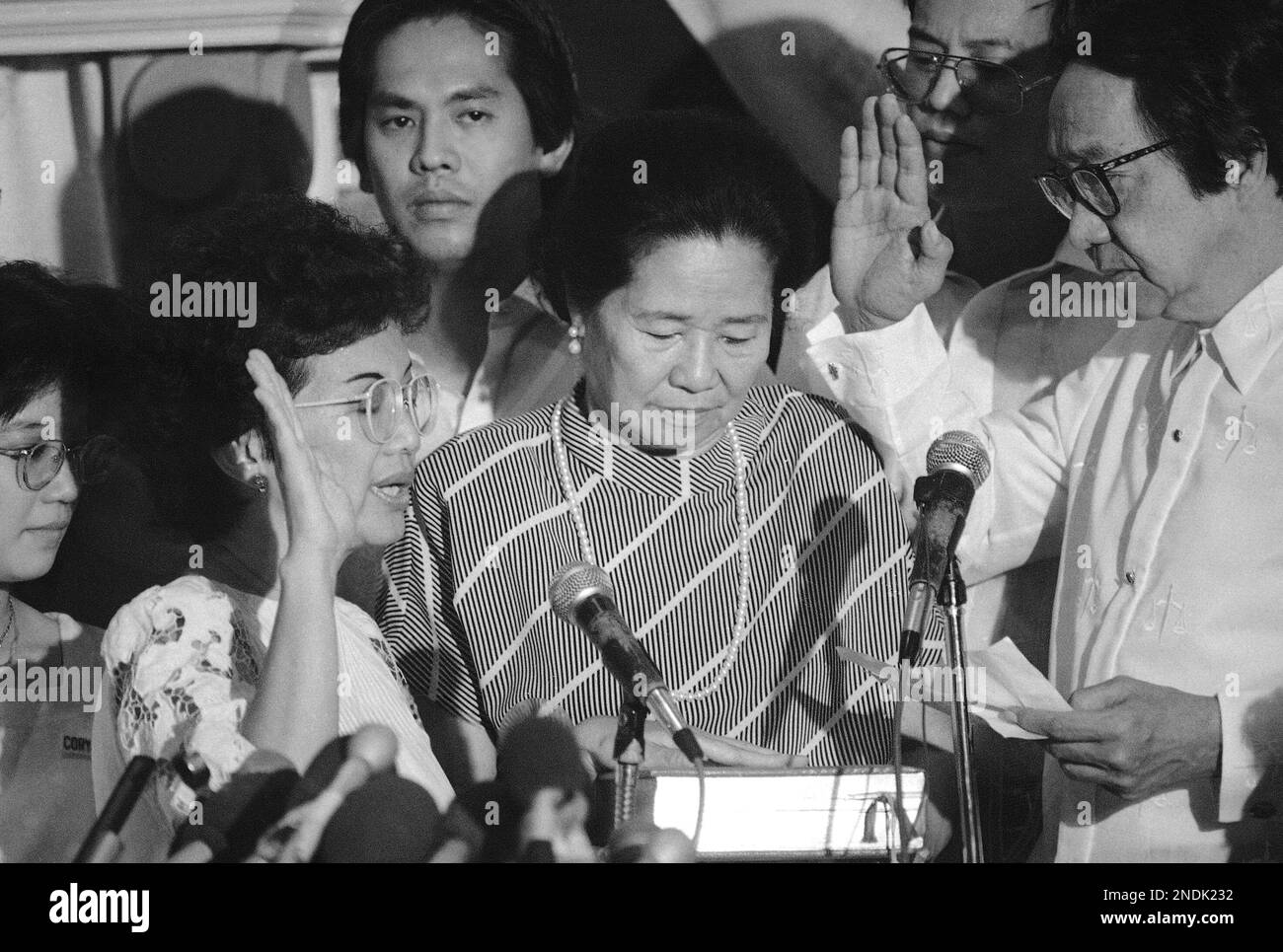 Corazon Aquino, left, takes the oath of office as President of the ...