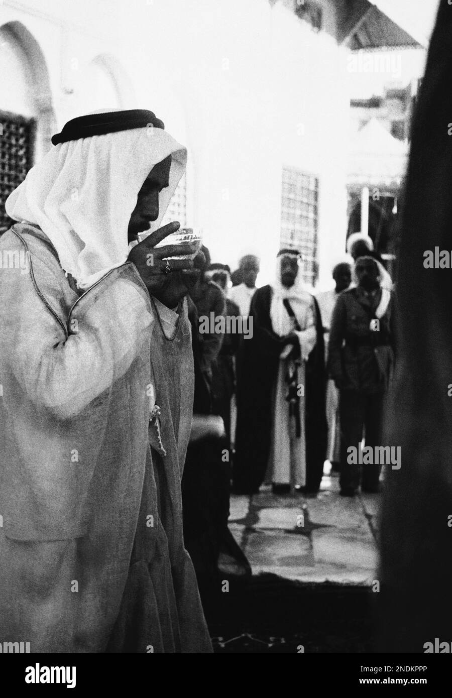 King Talal of Jordan drinks Holy Water from the Zamman Well during a ...