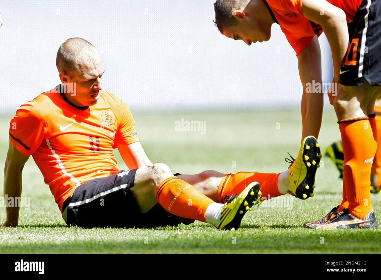 Arjen Robben of The Netherlands grimaces as Ibrahim Afellay, right ...