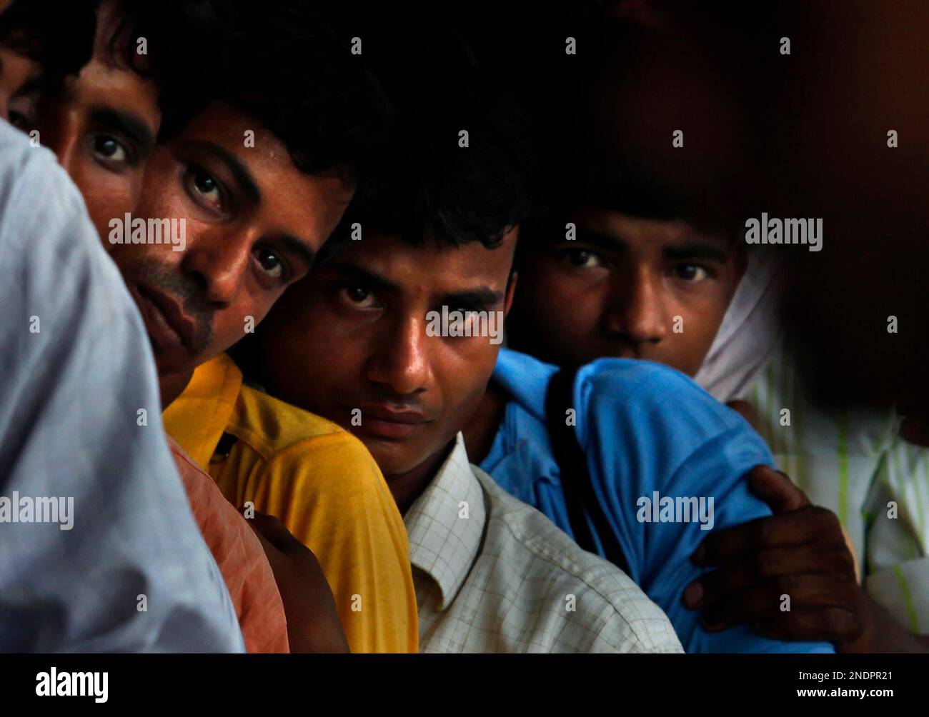 Indians wait in the heat to board a crowded train at a station in New ...