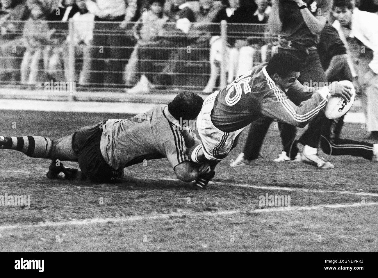 French fullback Serge Blanco dives across the line to score despite the ...