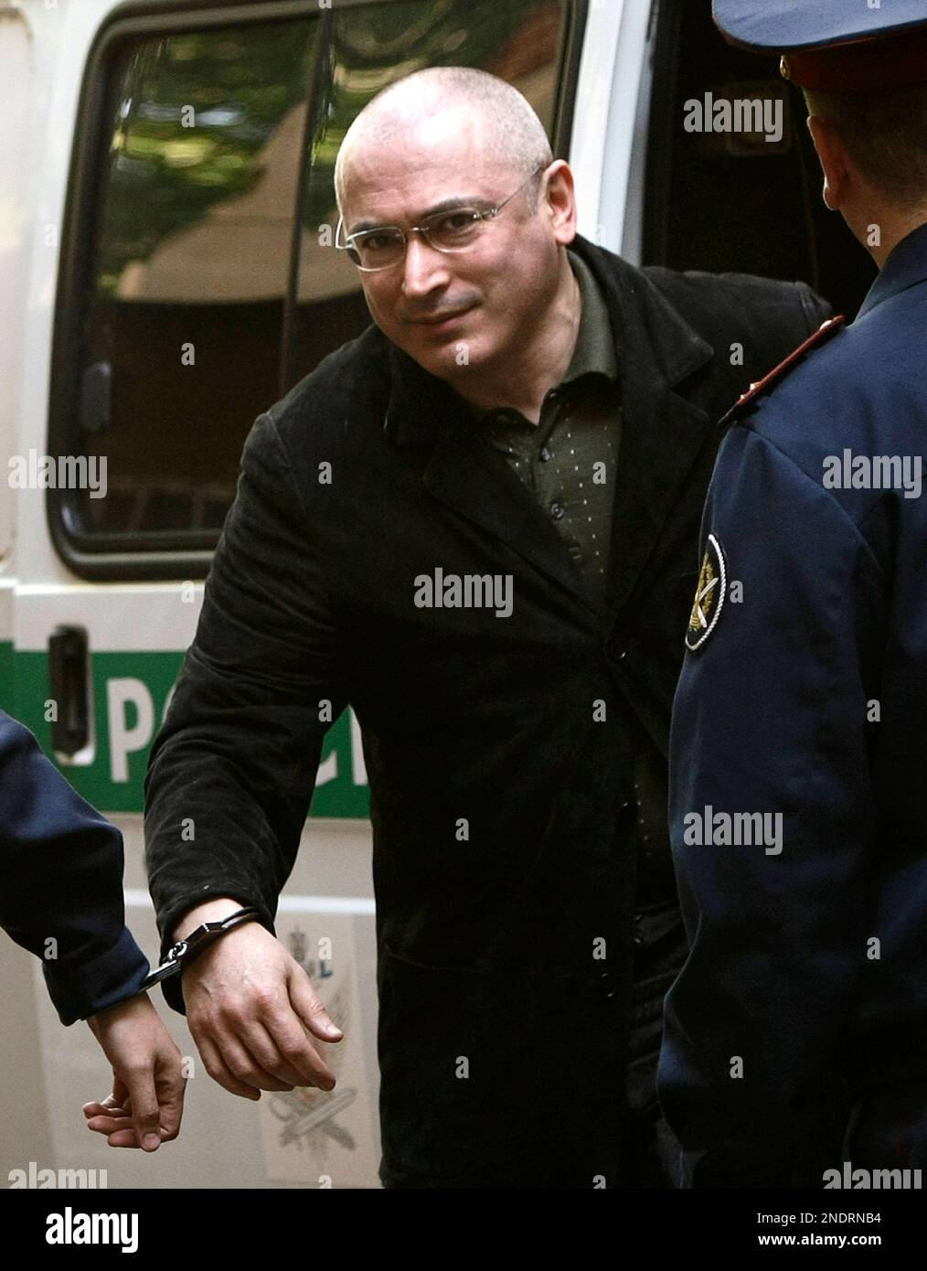 Former Yukos CEO Mikhail Khodorkovsky Center Is Escorted Into A Court
