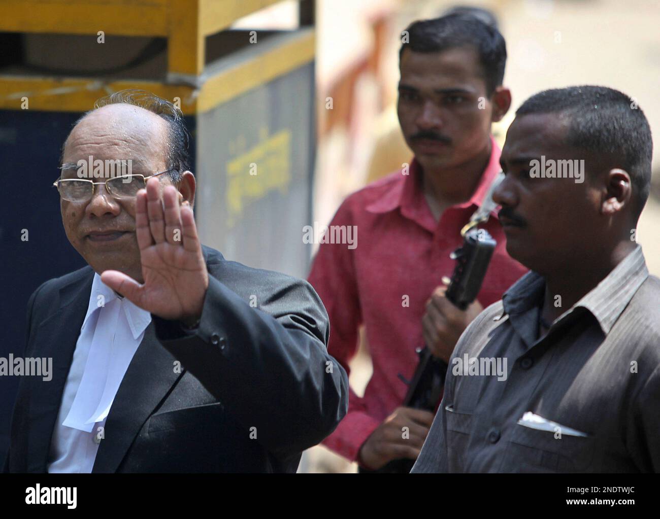 Defense lawyer K.P. Pawar gestures as he arrives to the special court set up for the trial of ...