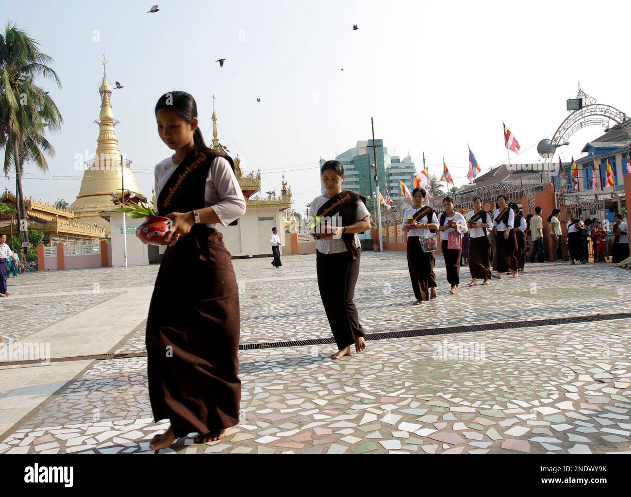 Myanmar Buddhist devotees carry holy water during the cerebration of ...