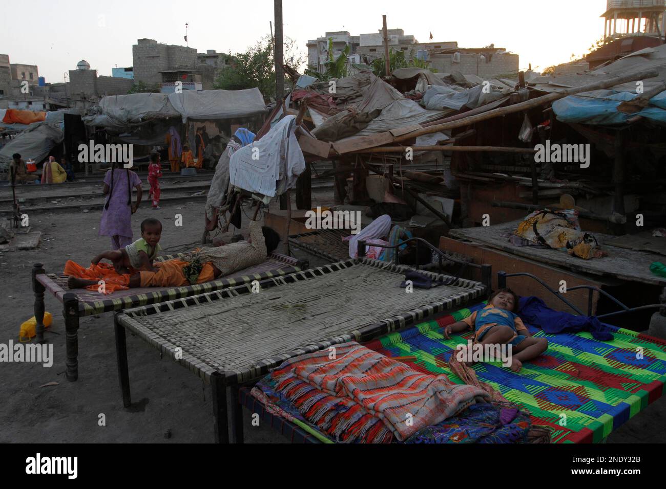 Poor Pakistani families live along a railway track in Karachi, Pakistan ...