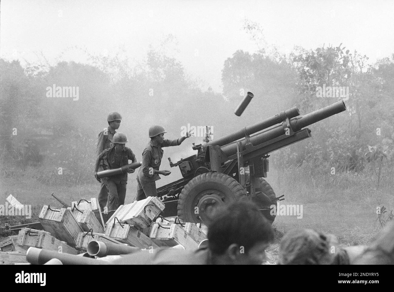 A South Vietnamese artillery crew works double time as they fire their ...