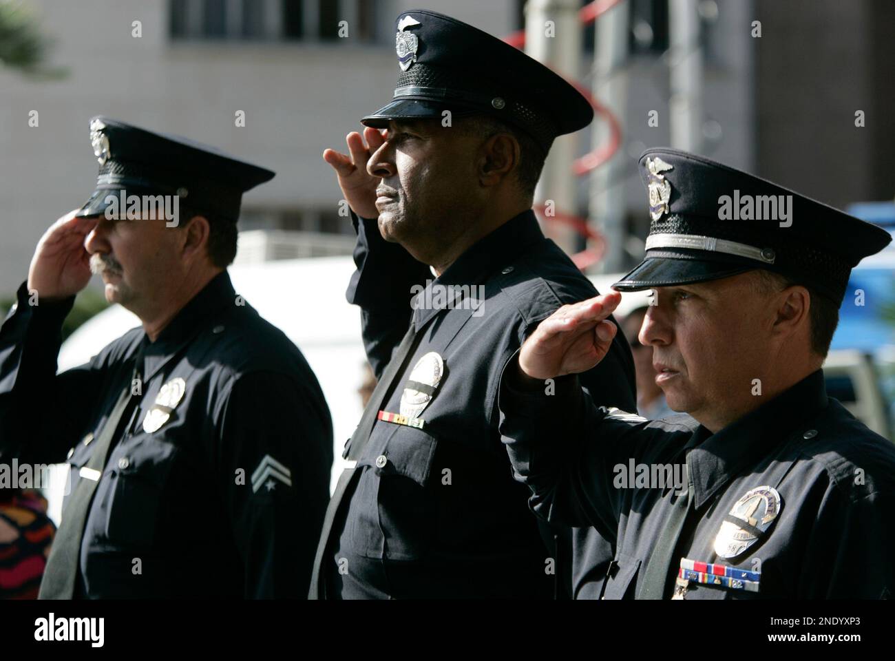 Los Angeles Police Department officers salute the flag-draped casket of ...