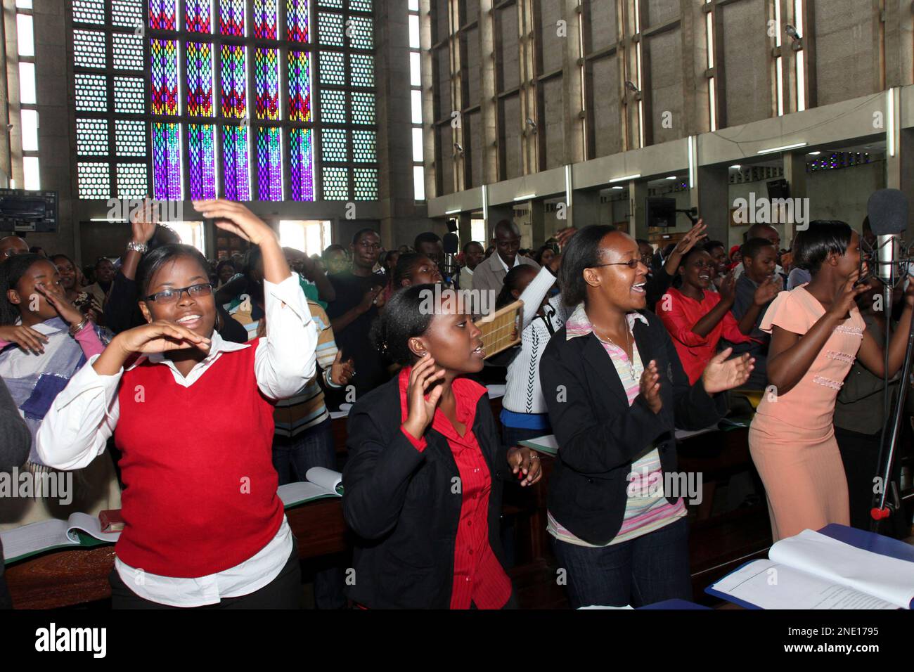 Kenyan Christian sing and praise the Lord as they join a morning ...