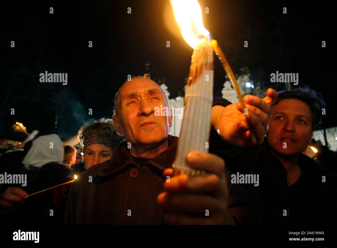 Ukrainian Orthodox faithful light candles from the Holy Fire brought ...
