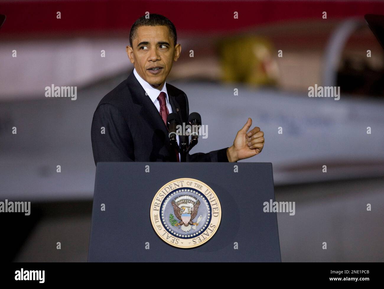 President Barack Obama points towards an F-18 "Green Hornet" that will ...