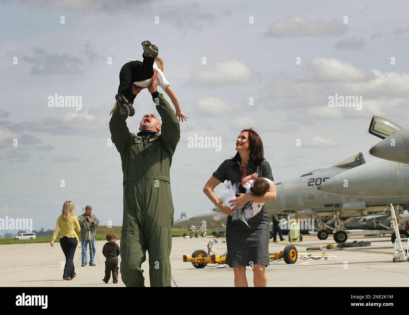 Thomas Locke, a pilot for the VFA-14 Top Hatters, throws his son Jake ...