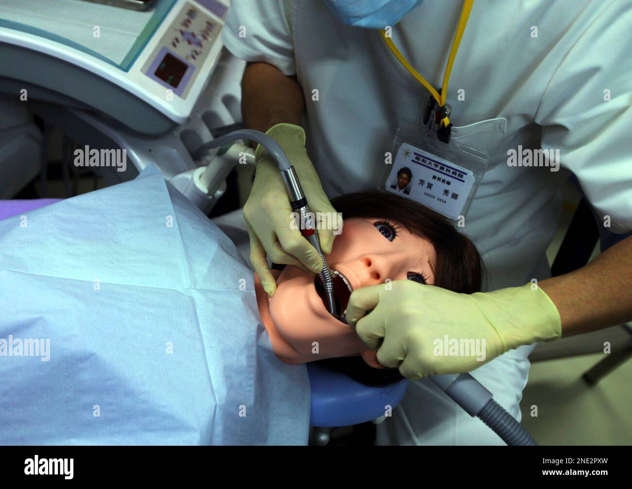 A dentist demonstrates a training procedure, using the new humanoid ...