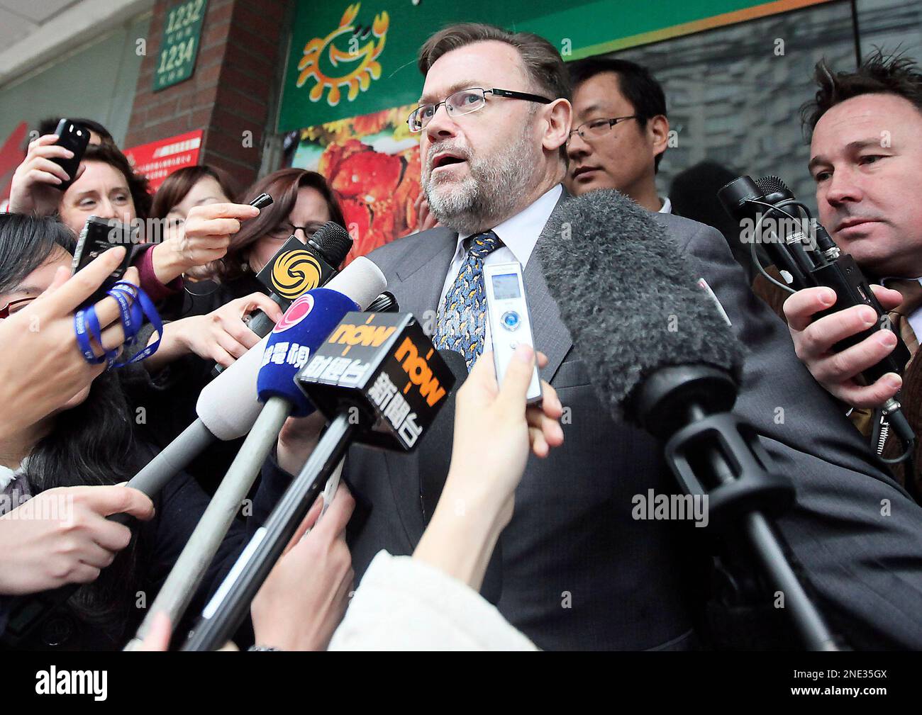 Tom Connor, Australia's consul-general in Shanghai, center, speaks to ...