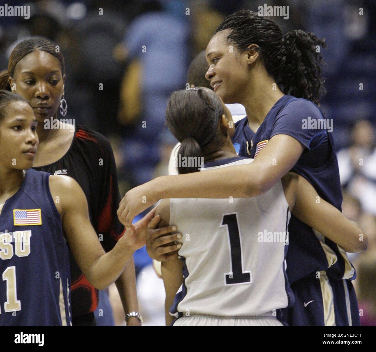 Xavier guard Special Jennings (1) hugs East Tennessee State forward ...