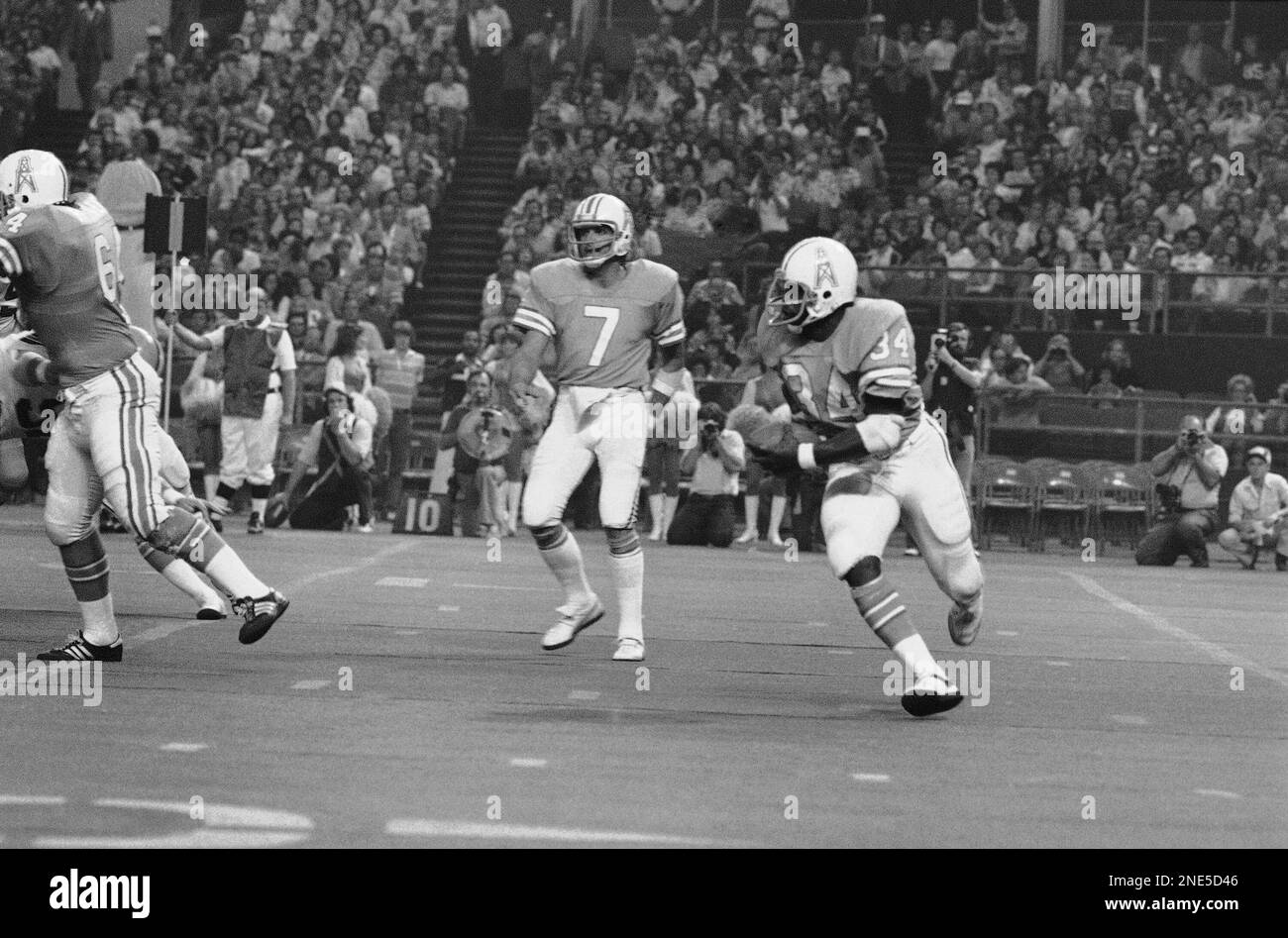 Houston Oilers Earl Campbell (34) looks for running room after taking a ...