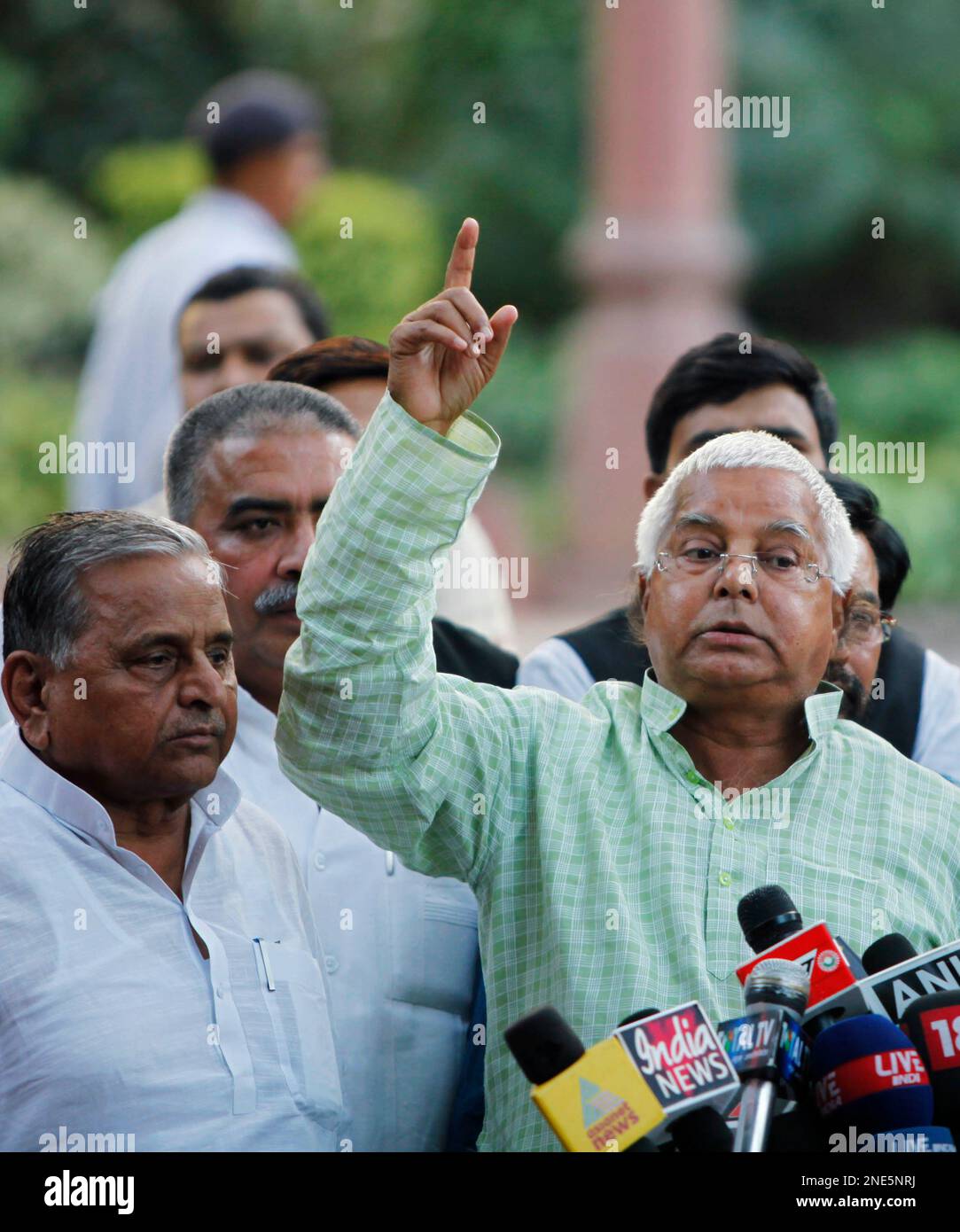 Samajwadi Party leader Mulayam Singh Yadav, left, looks on as Rashtriya Janata Dal party ...