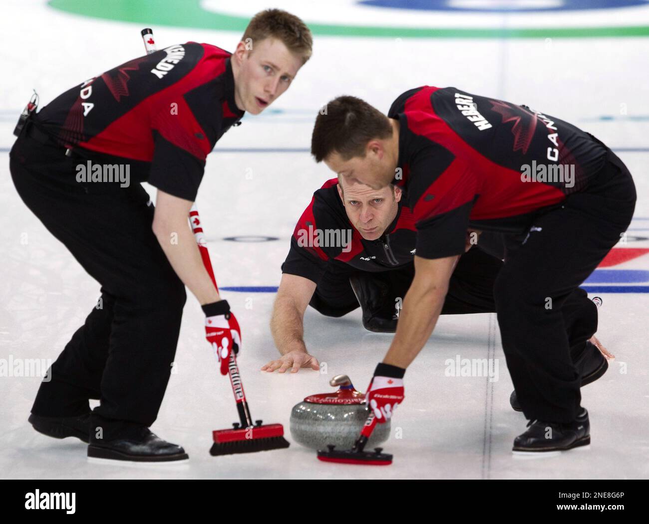 Team Canada skip Kevin Martin, centre, watches his rock as second Marc ...