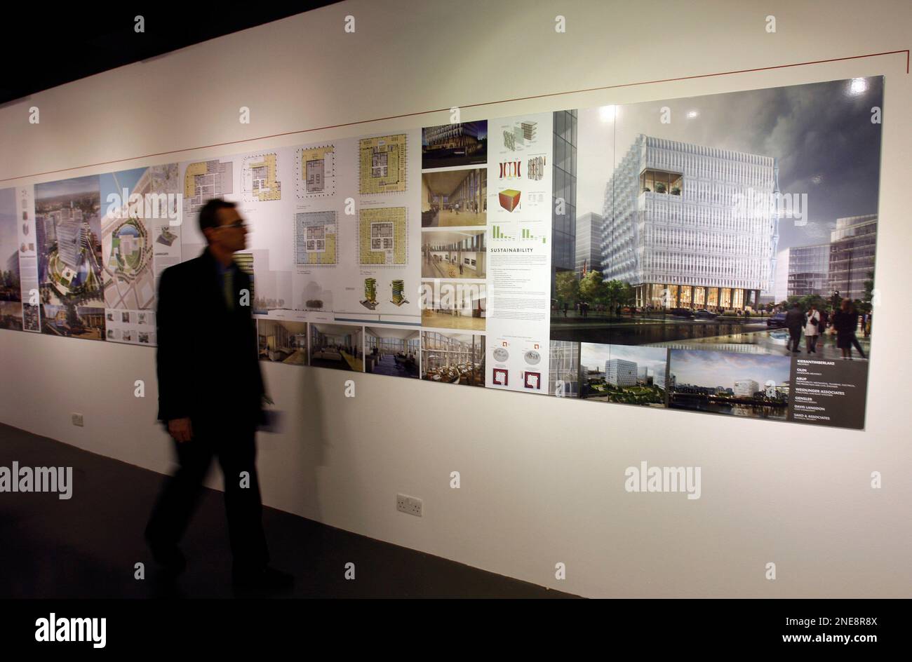 A visitor looks at drawings of the winning design for the new US ...