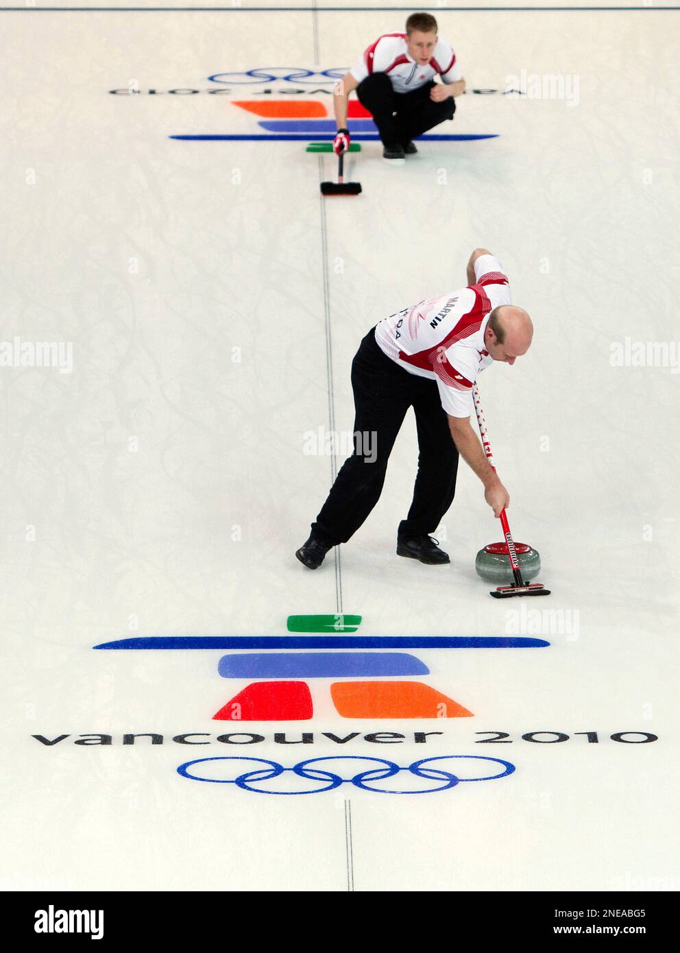 Team Canada Skip Kevin Martin, front, sweeps as second Marc Kennedy ...